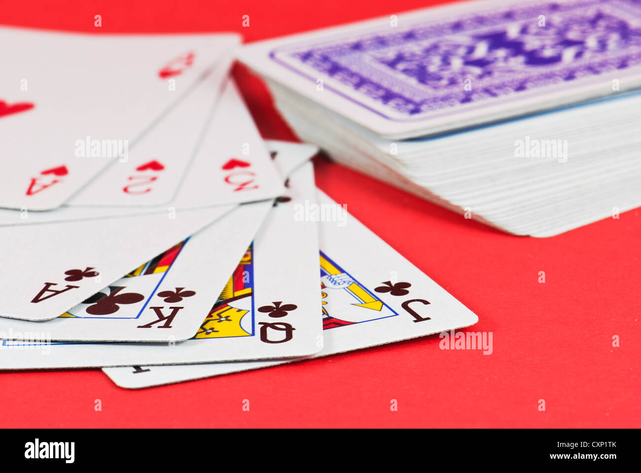 Dealt playing cards on red background Stock Photo - Alamy
