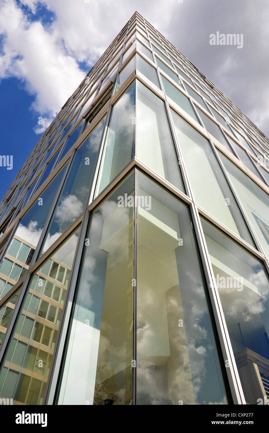 The corner of an office building seen from below and with a blue sky ...