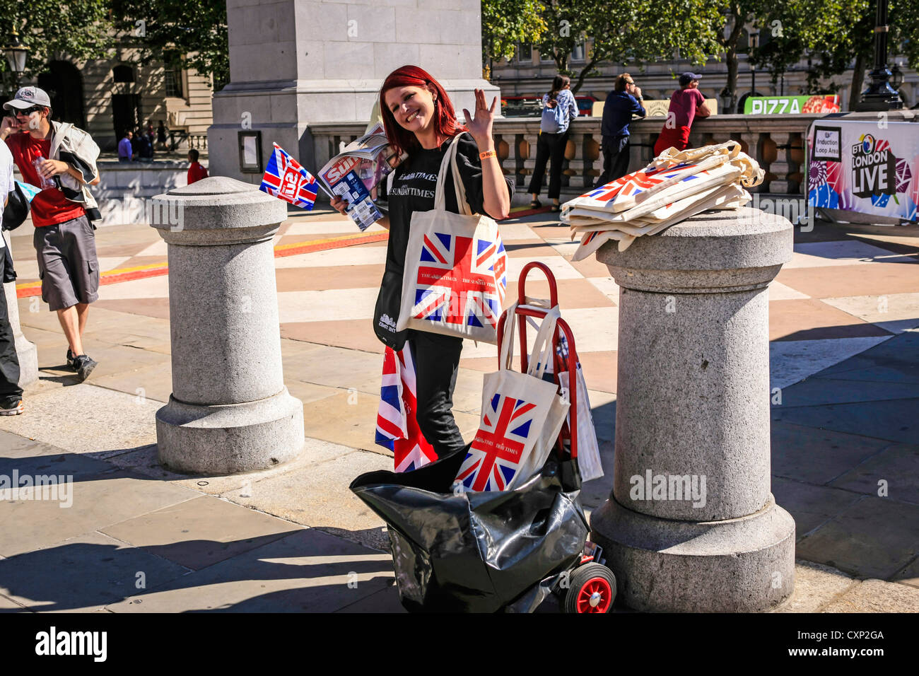 Young promotions woman selling a daily newspaper in London Stock Photo ...