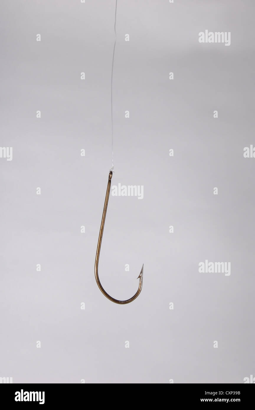 Fishing hook on line against a grey background Stock Photo - Alamy