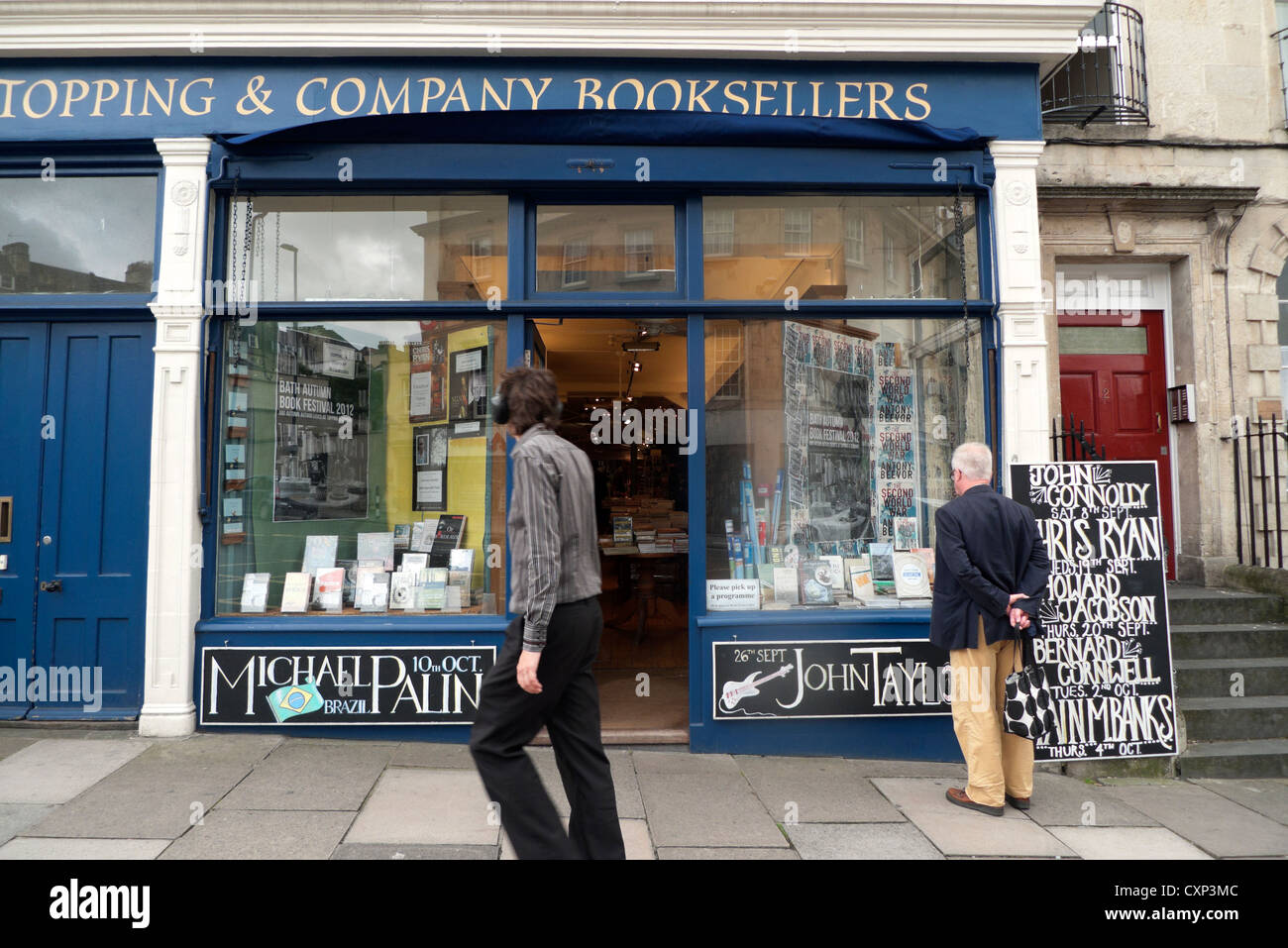 People looking in bookshop window of Topping & Company Booksellers shop ...
