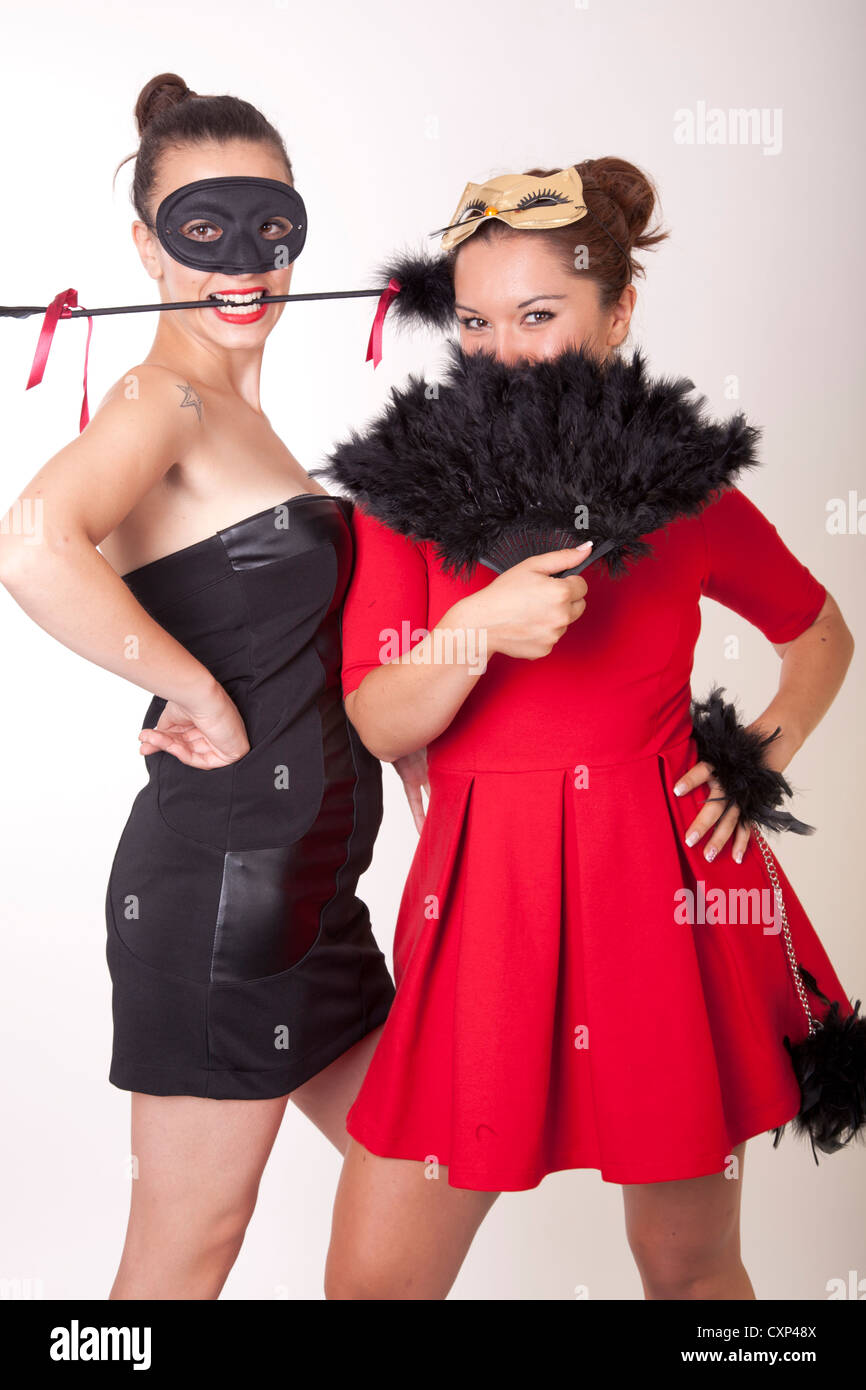 Portrait of a two beautiful masked women Stock Photo - Alamy