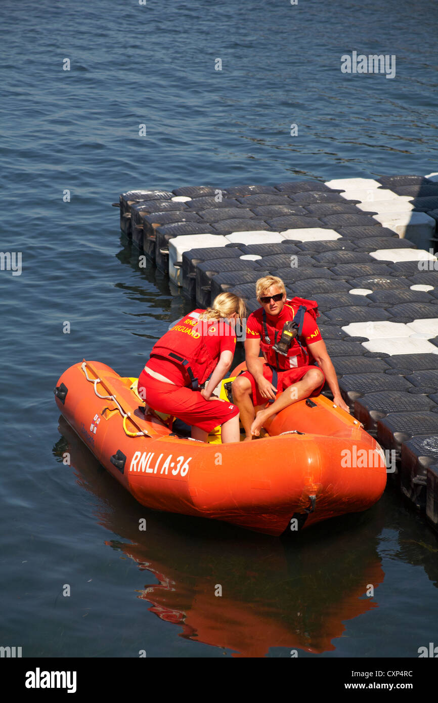 RNLI lifeguards patrolling in dinghy at Weymouth, Dorset UK in July ...