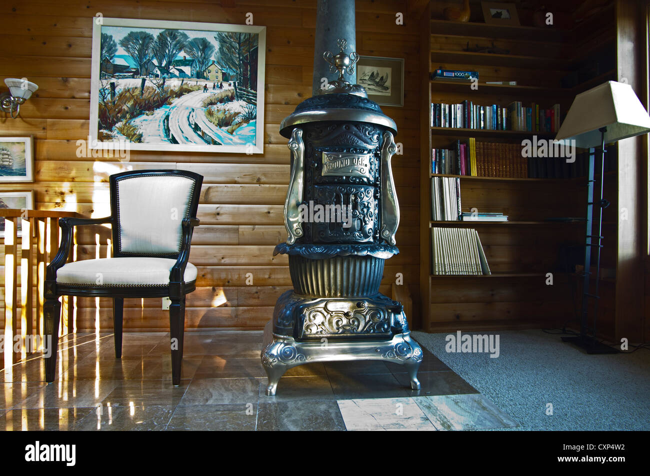 Antique wood stove in a library with a antique chair and wooden ...