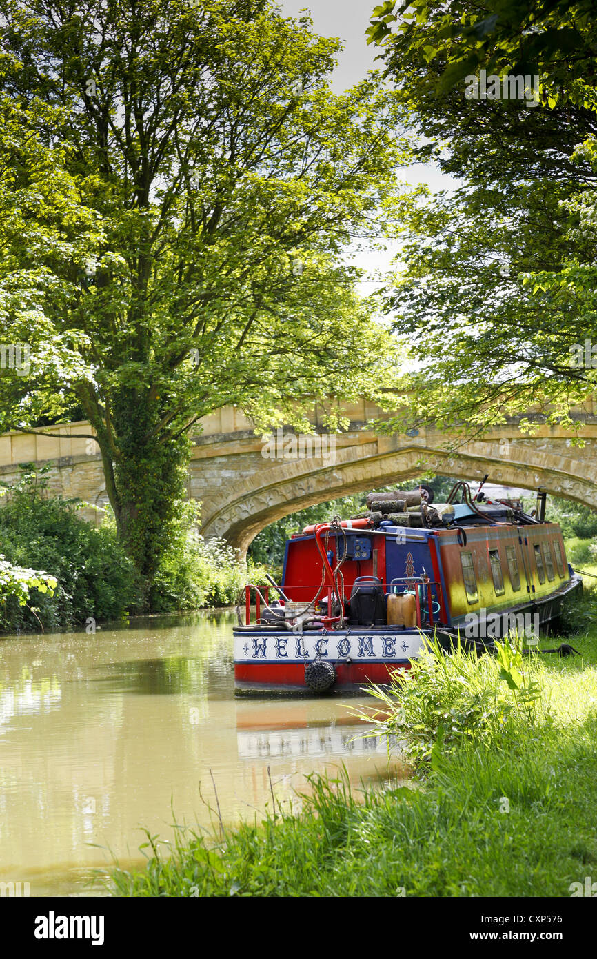 A beautifully painted canal boat under a stone bridge Stock Photo - Alamy