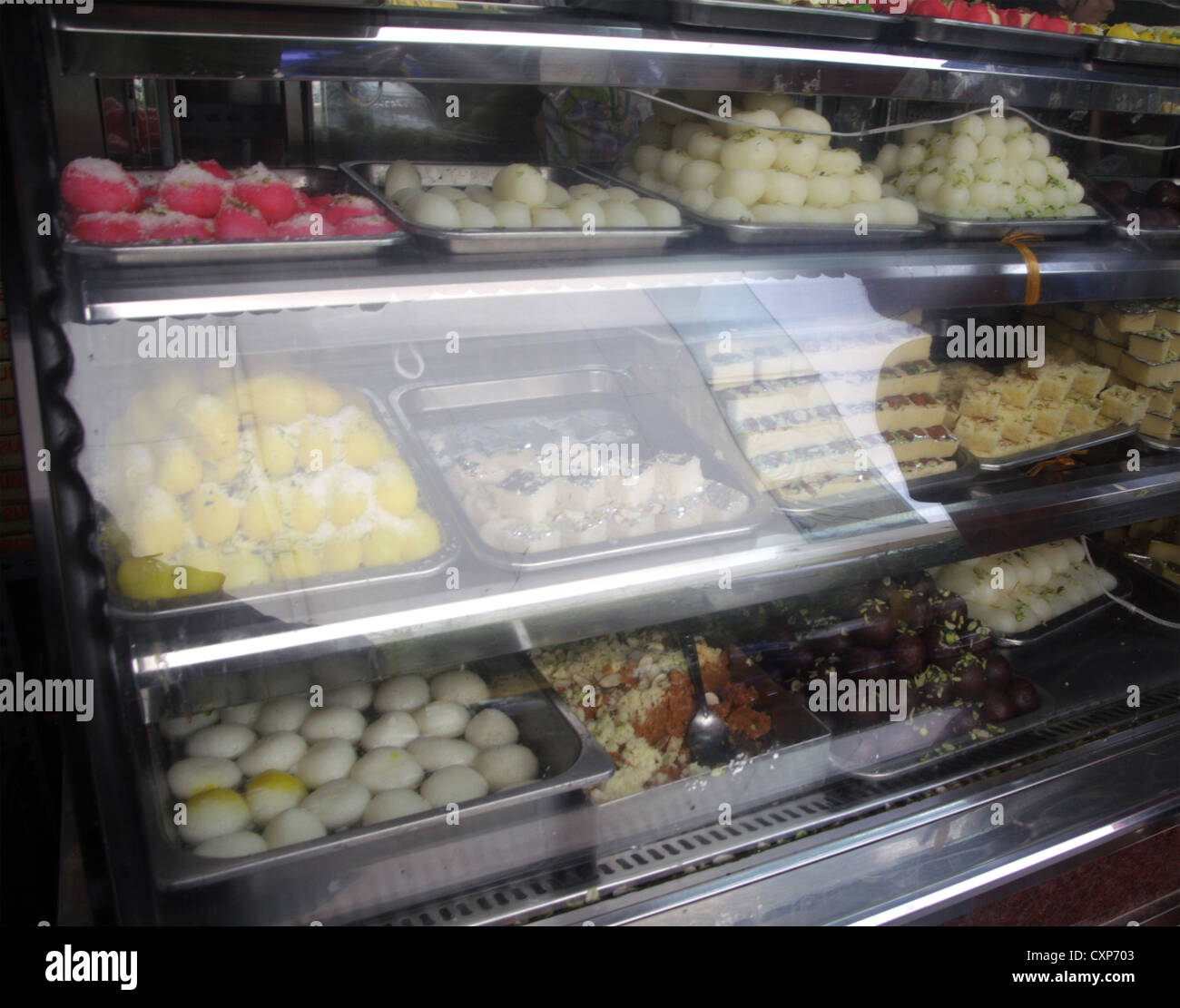 Indian sweets display in shop Stock Photo - Alamy
