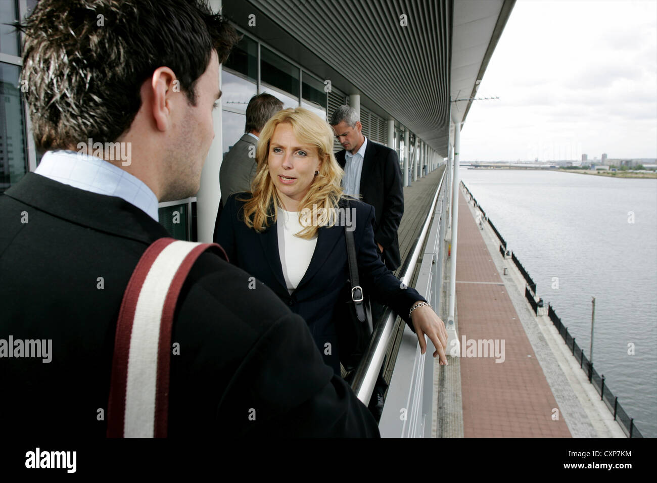Professionals talking on balcony outside office Stock Photo - Alamy