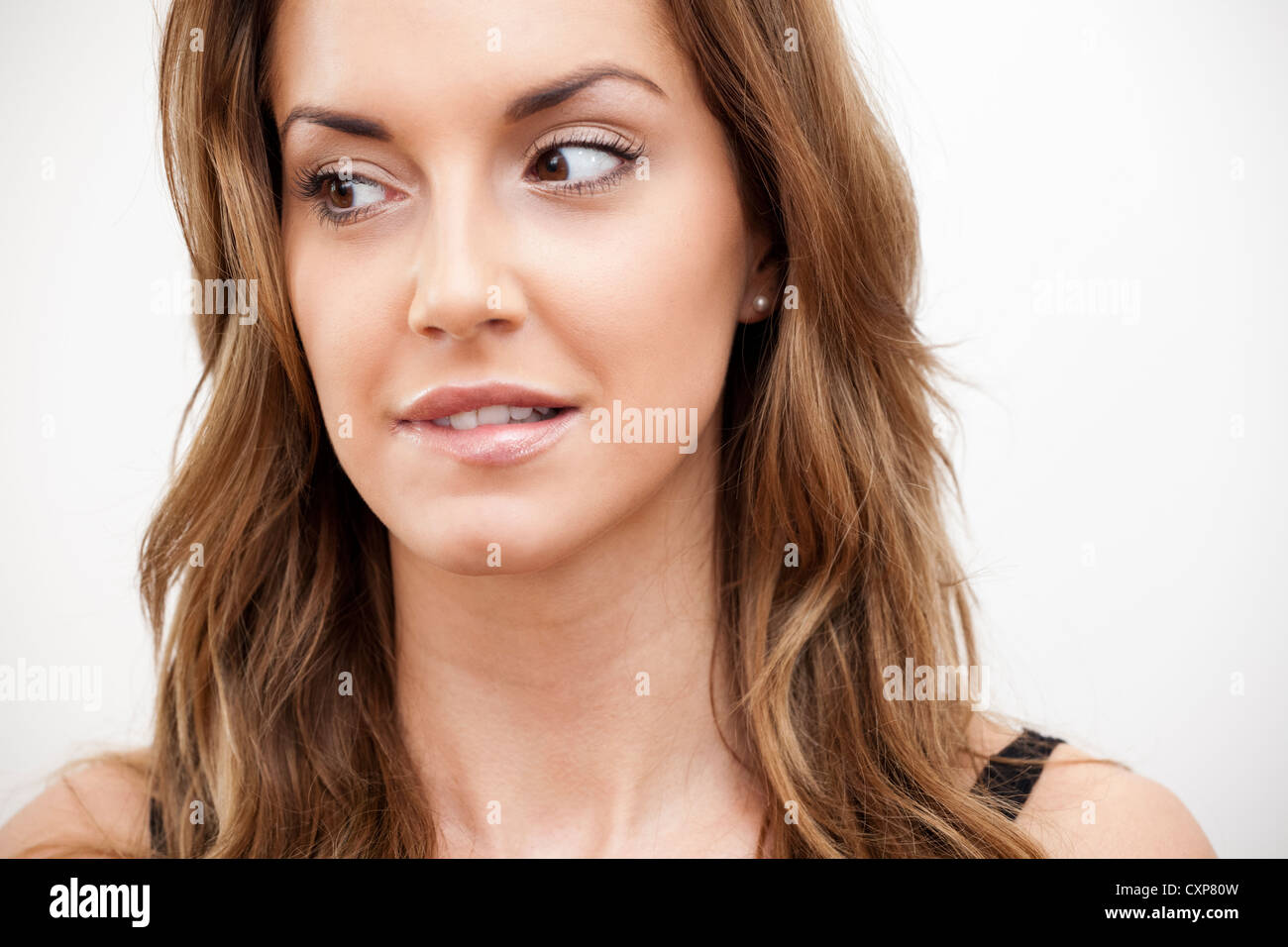 Woman biting her lip Stock Photo - Alamy