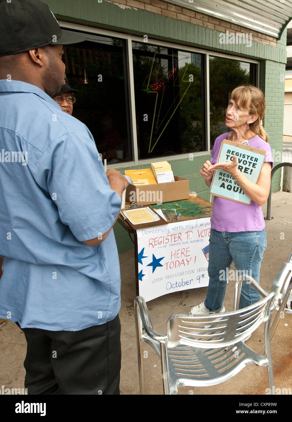 Volunteer deputy voting registrars register new voters at table set up ...