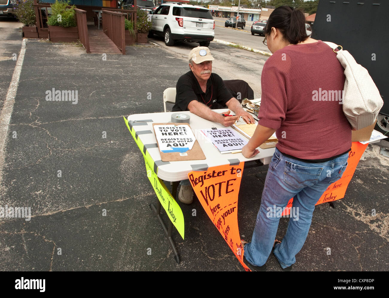 White male volunteer voter registrar sets up registration table in ...