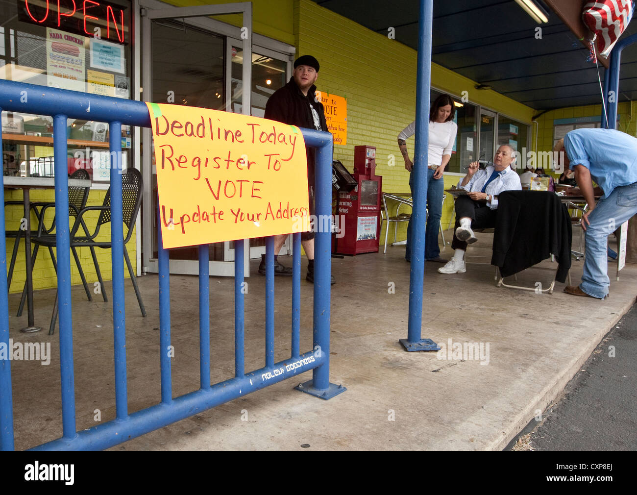Volunteer deputy voting registrars register new voters at table set up ...
