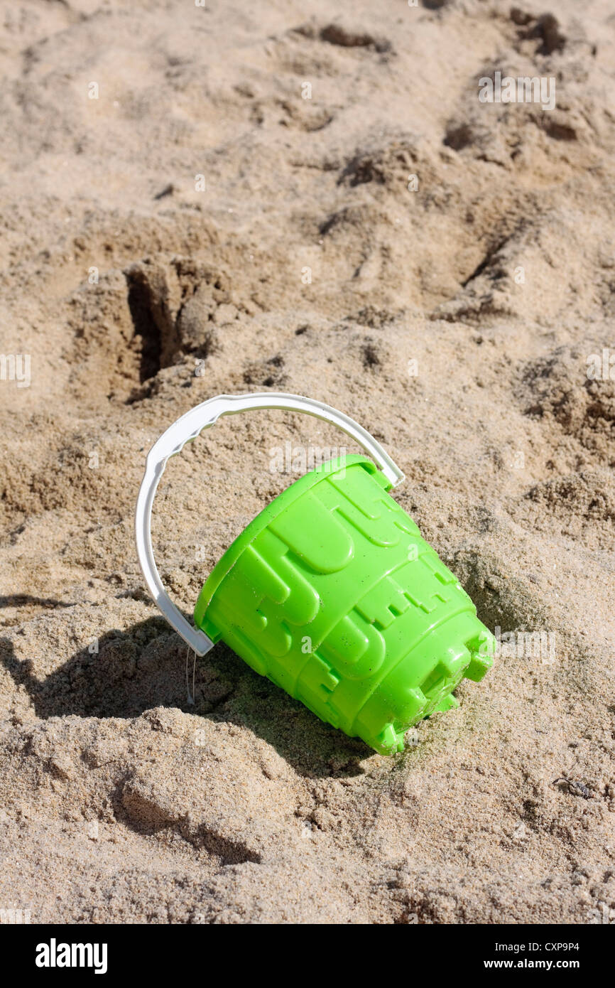 Empty green bucket on beach Stock Photo - Alamy