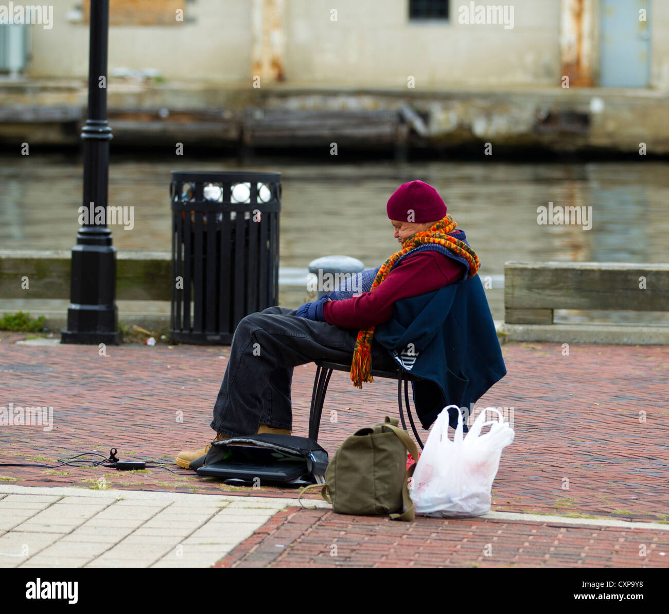 A homeless man sitting on a chair Stock Photo - Alamy