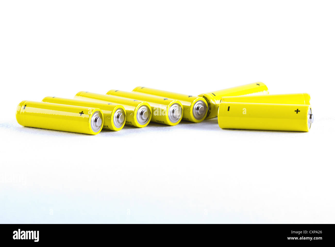 Few yellow power batteries on white Stock Photo - Alamy