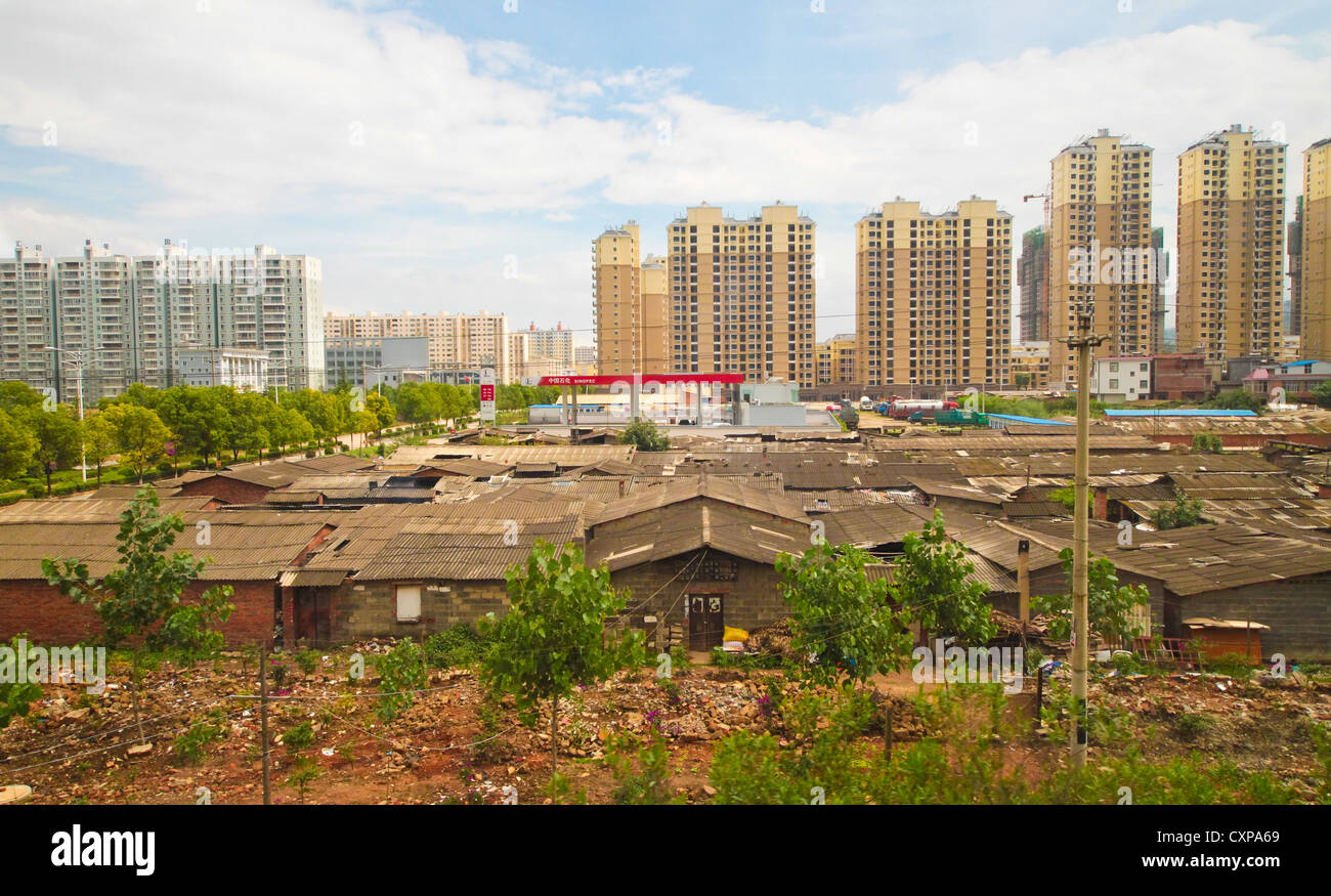 Low income suburban housing in front some high rise building at a big ...