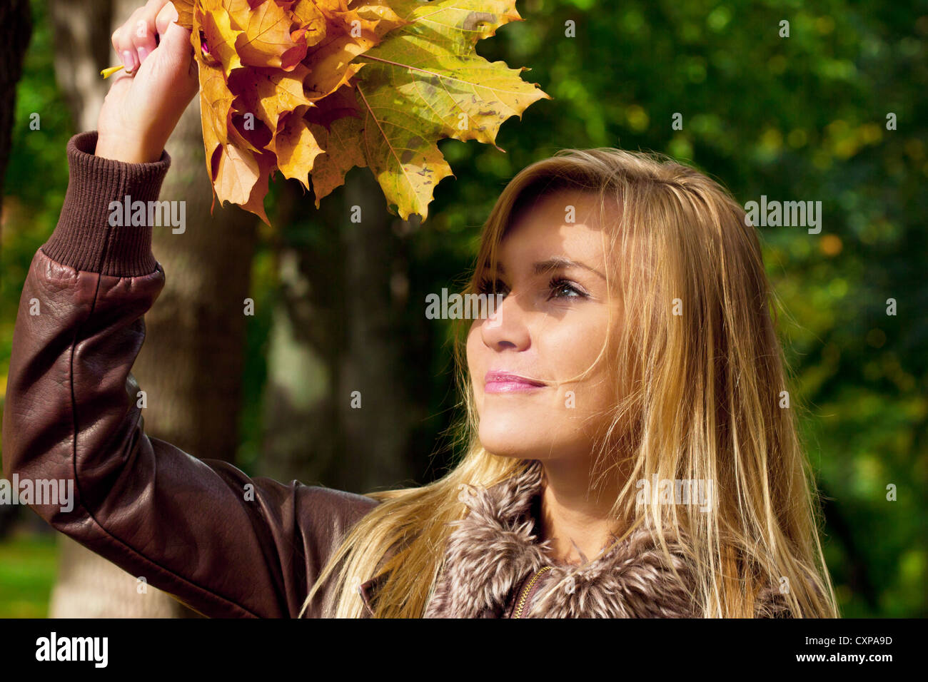 Young beautiful autumn woman in park Stock Photo - Alamy