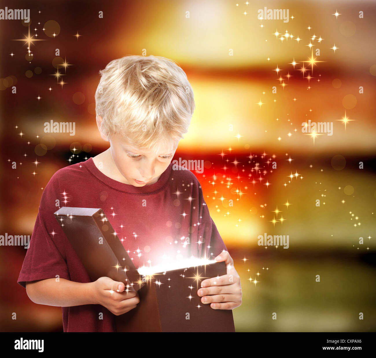 Happy Young Blond Boy Opening a Gift Box Stock Photo - Alamy