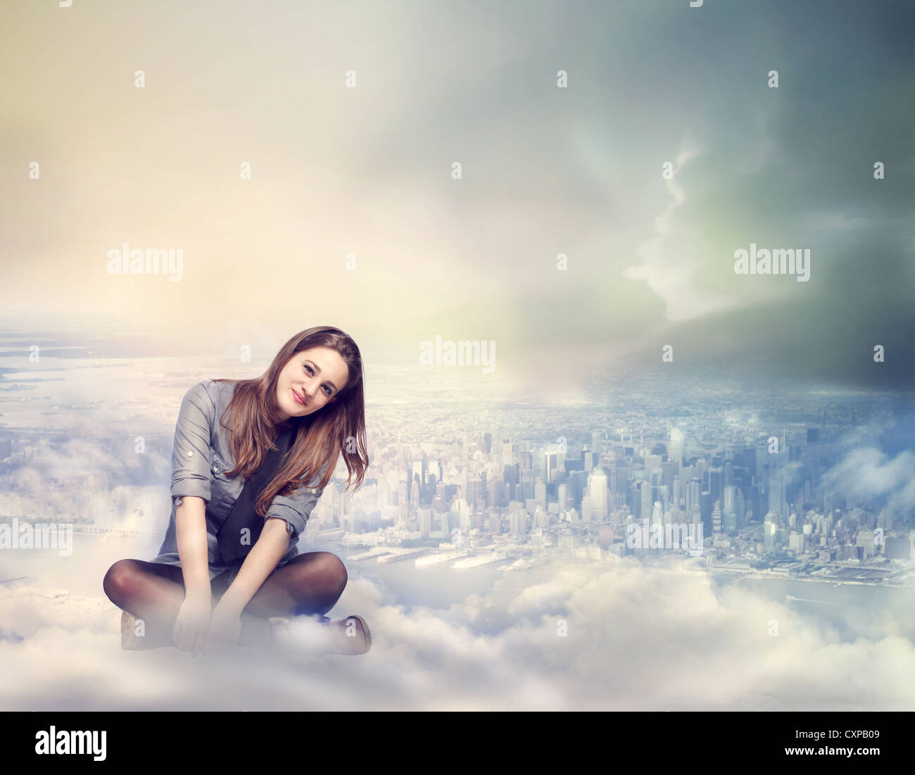 Happy Young Woman Sitting on the Clouds Stock Photo - Alamy
