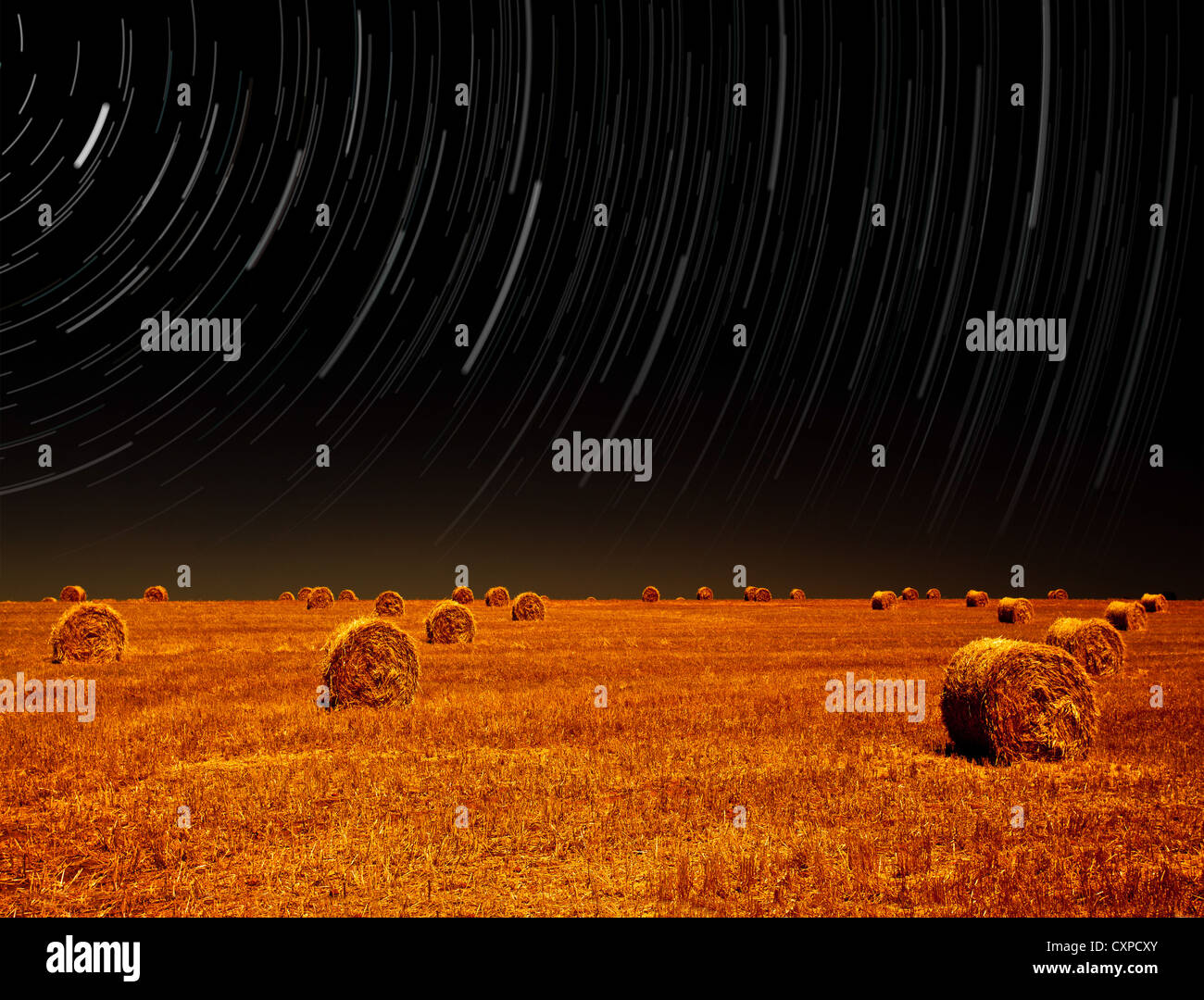 Picture of night landscape of farm field, starry sky above dry haystack ...