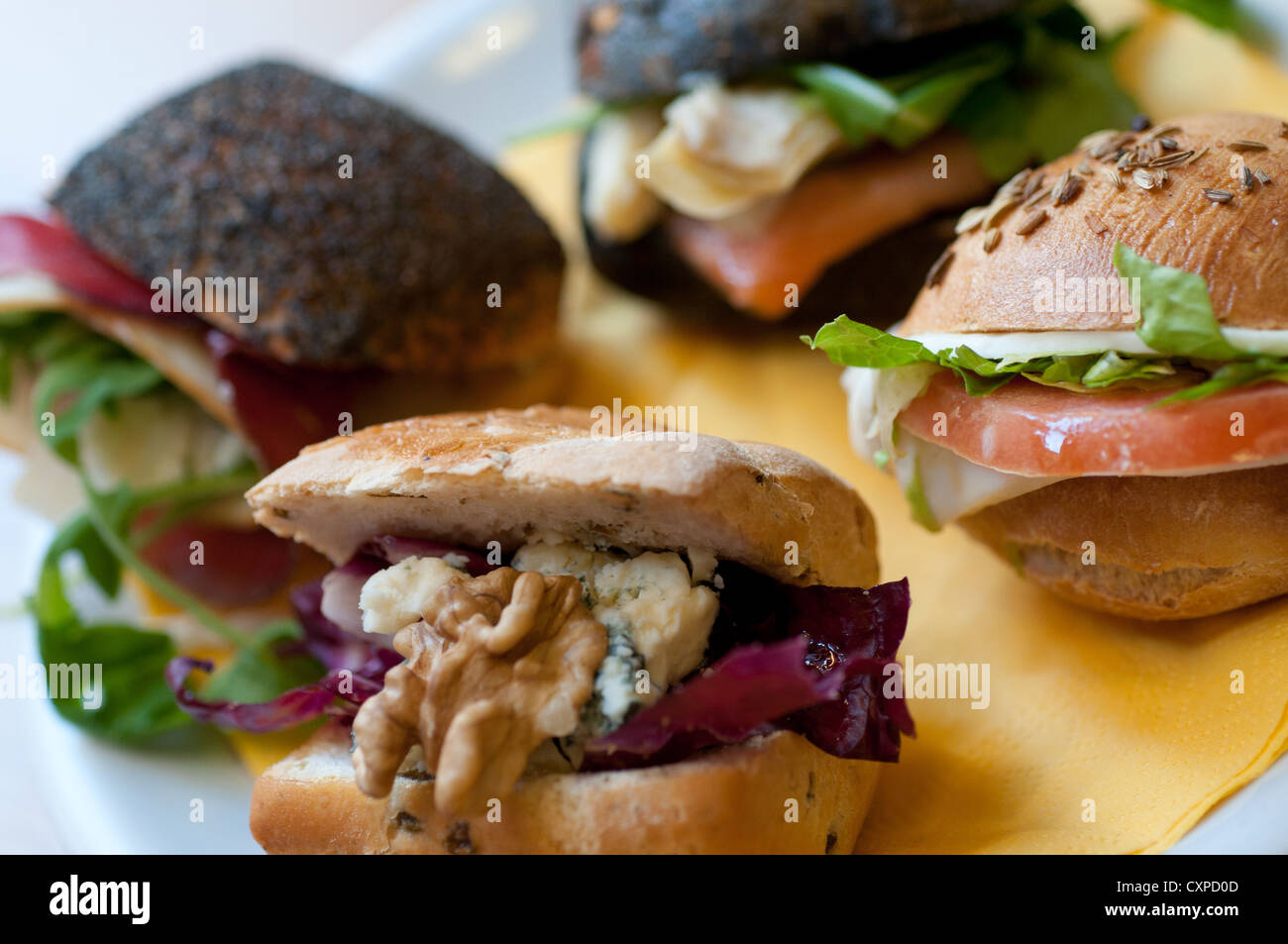 Close up of several delicious sandwiches, with tomato, nuts, and ...