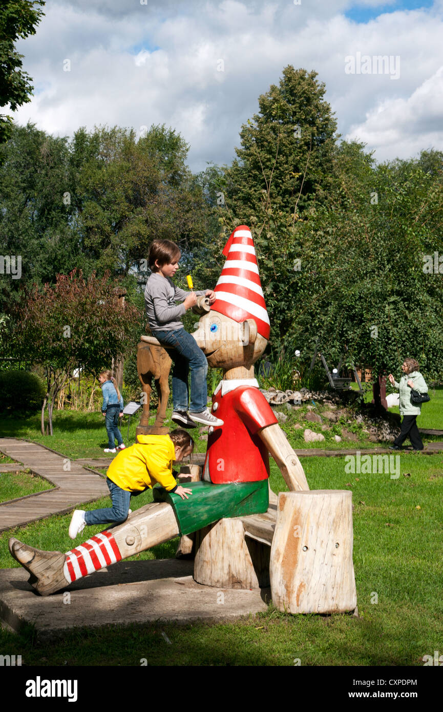 Kids climbing on a Pinocchio sculpture in the sculpture park of Moscow ...