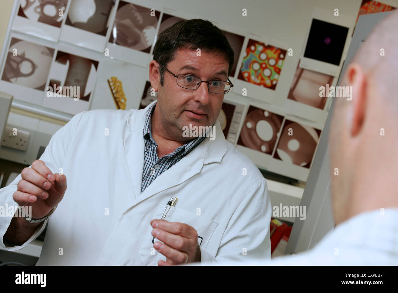 Scientist explaining in laboratory Stock Photo - Alamy