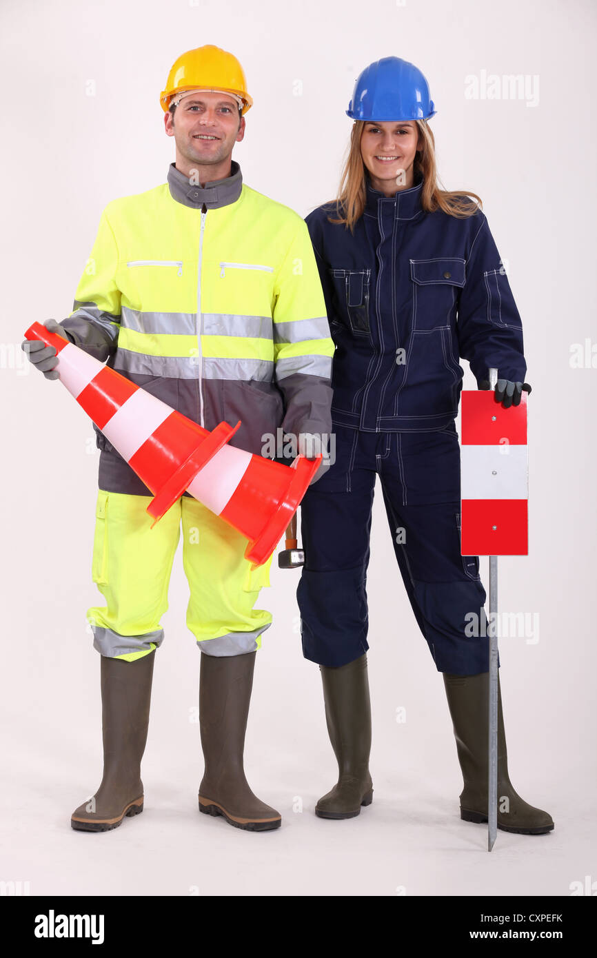 Construction workers with cones Stock Photo - Alamy