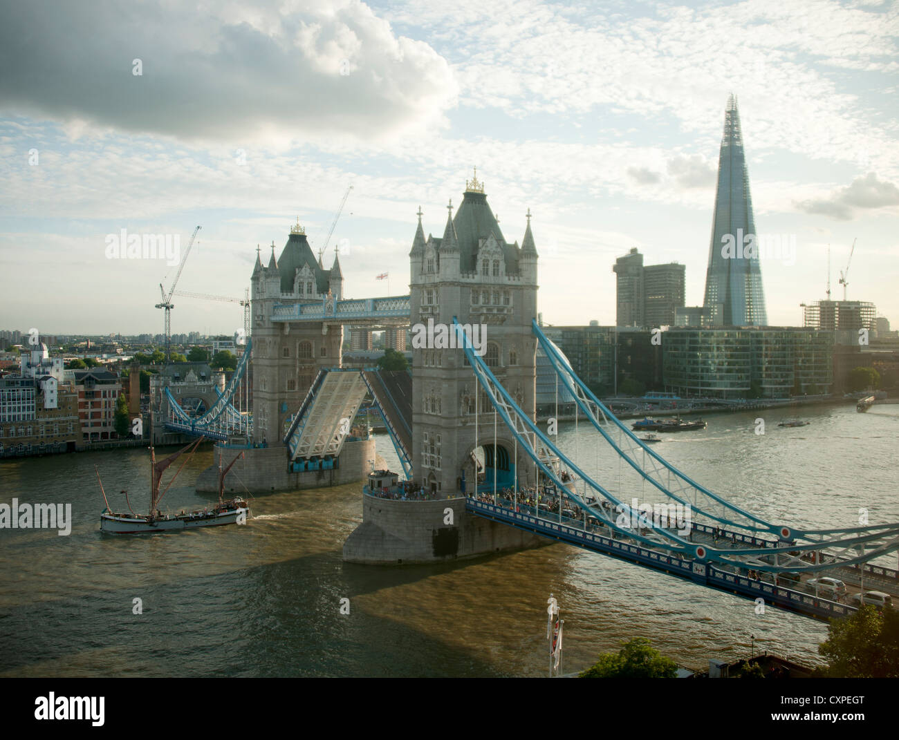 View across the River Thames of Tower Bridge with bascules raised and ...