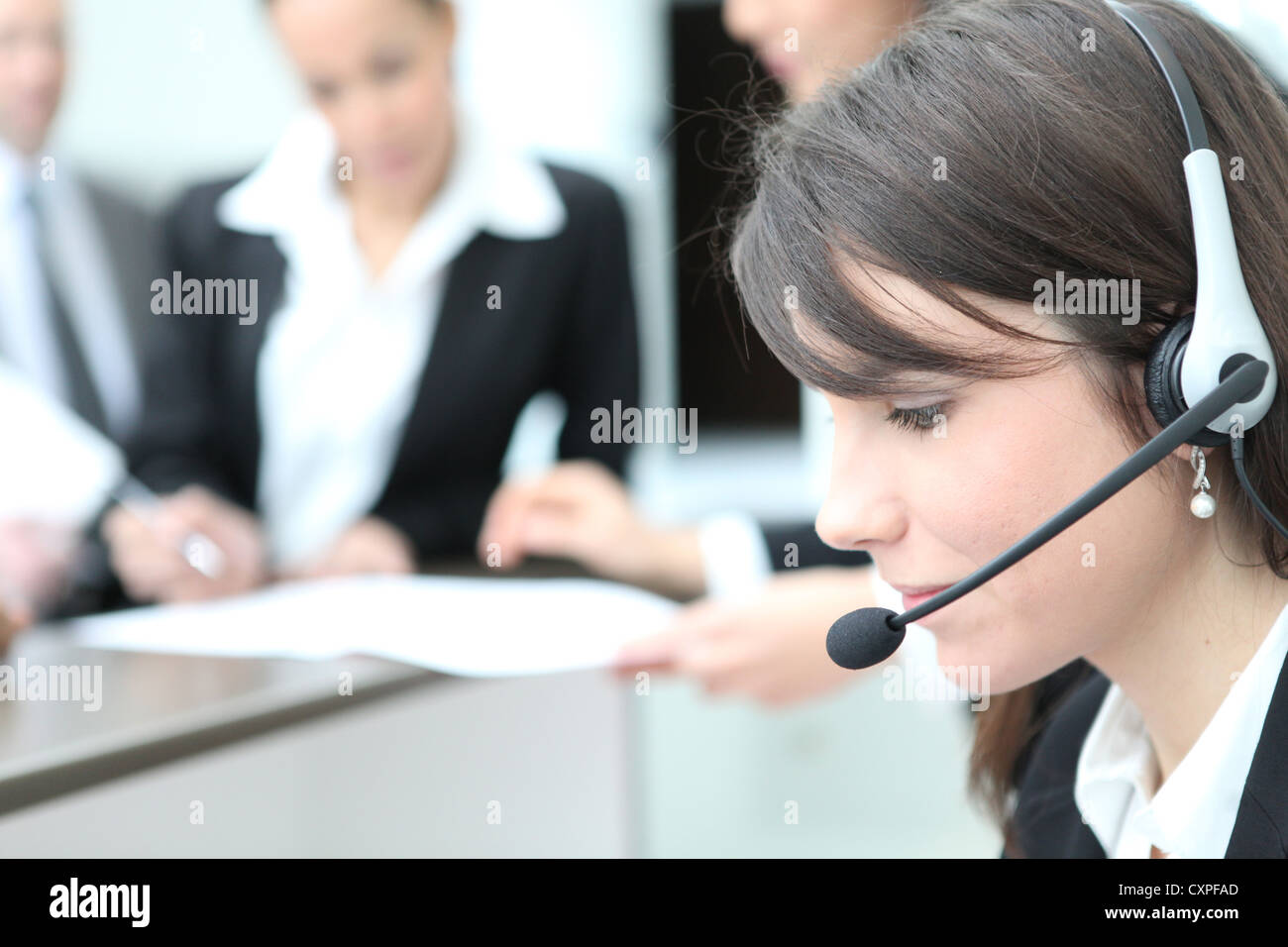 Young receptionist with headset Stock Photo - Alamy