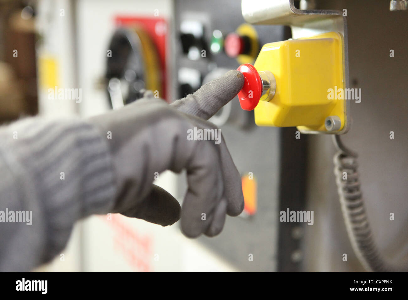 Factory worker pushing a button Stock Photo - Alamy