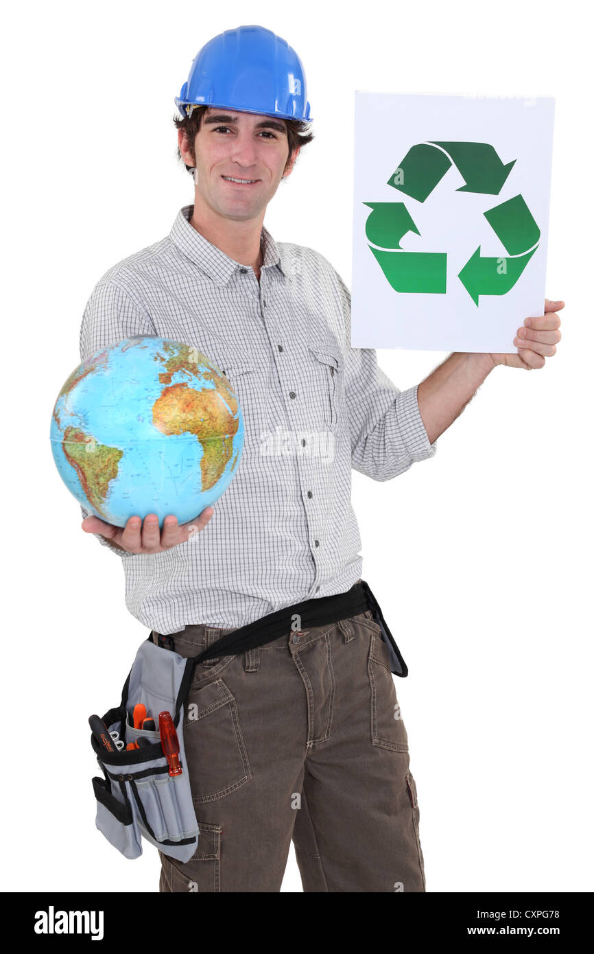 Laborer holding a globe and a symbol of recycling Stock Photo - Alamy