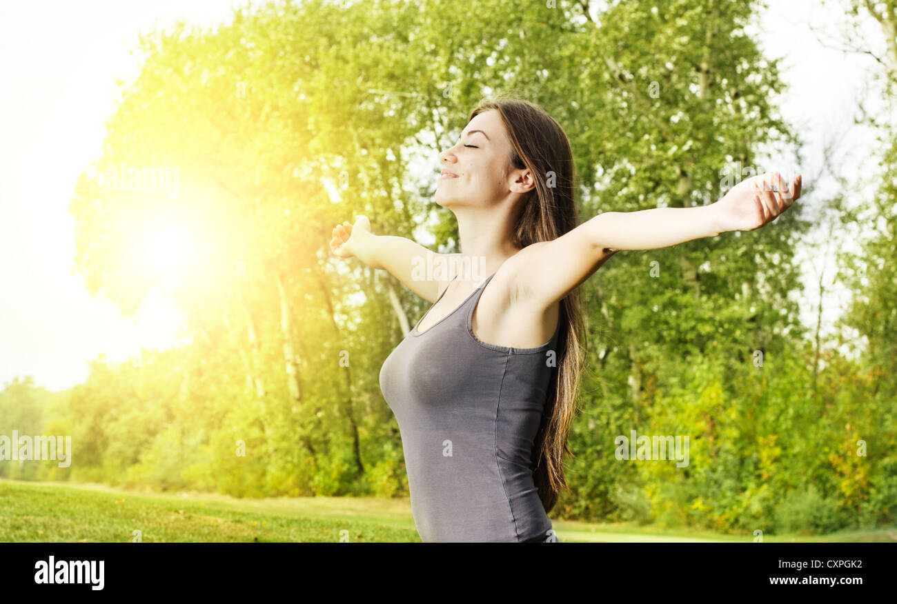 Happiness girl with open hands enjoyment nature at beautiful sunny day ...