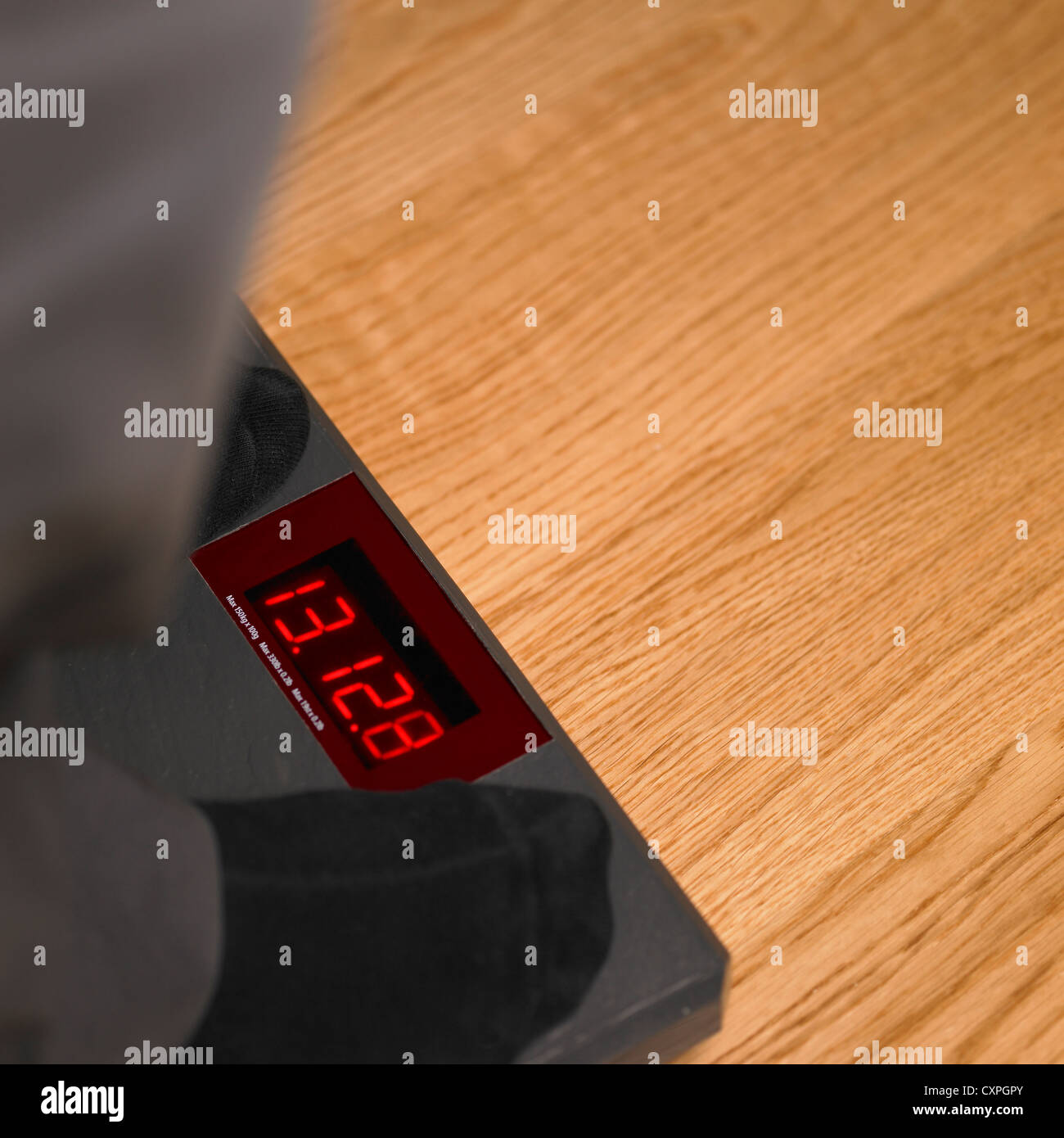 Mans feet on bathroom digital scales with wood floor background Stock ...