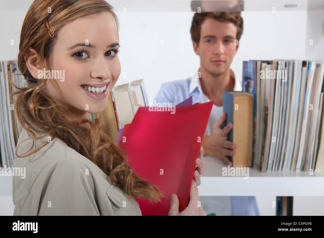 Two students in the library Stock Photo - Alamy