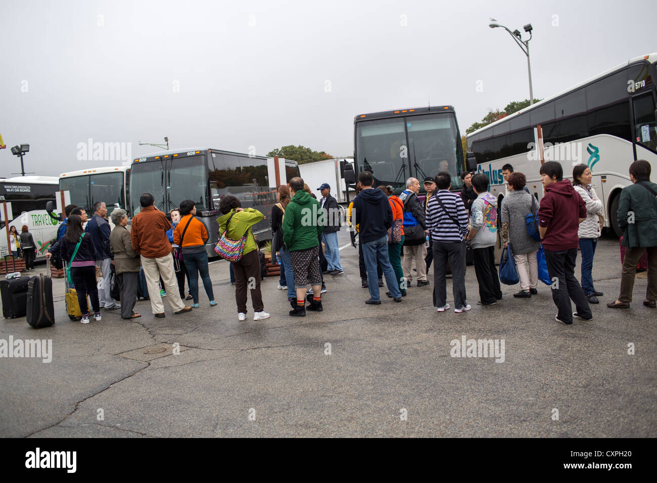 Chinese tourists wait to board their buses at a highway restaurant rest ...