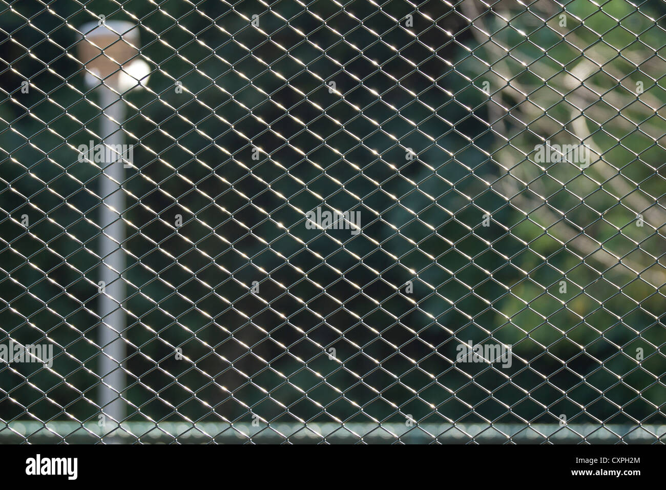 Metal net barrier with street lamp Stock Photo - Alamy