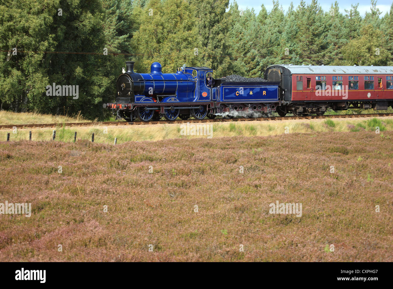 Steam engine traveling through the highland scenery from Boat of Garten ...