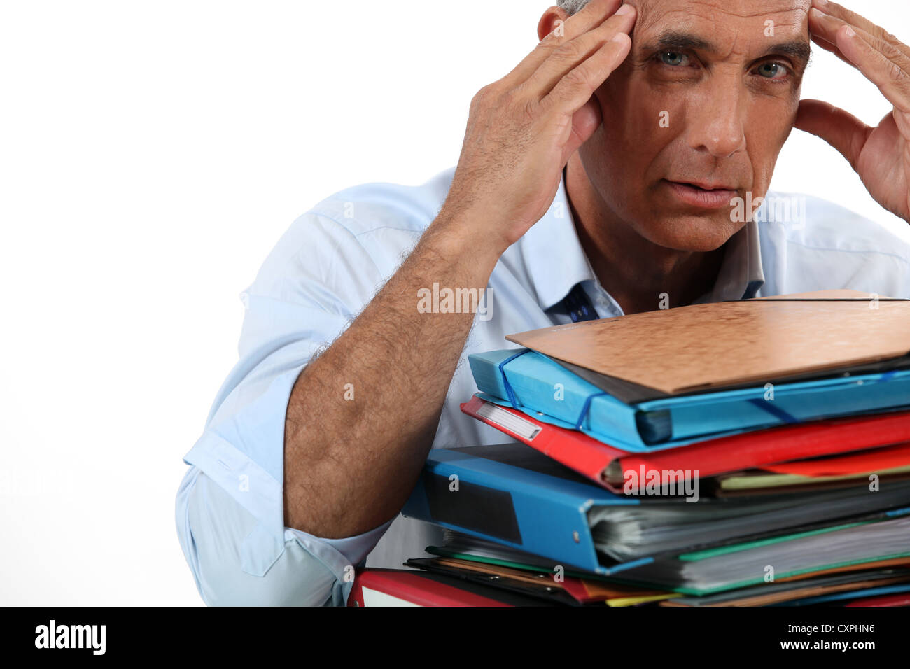 Man with stacks of work Stock Photo - Alamy