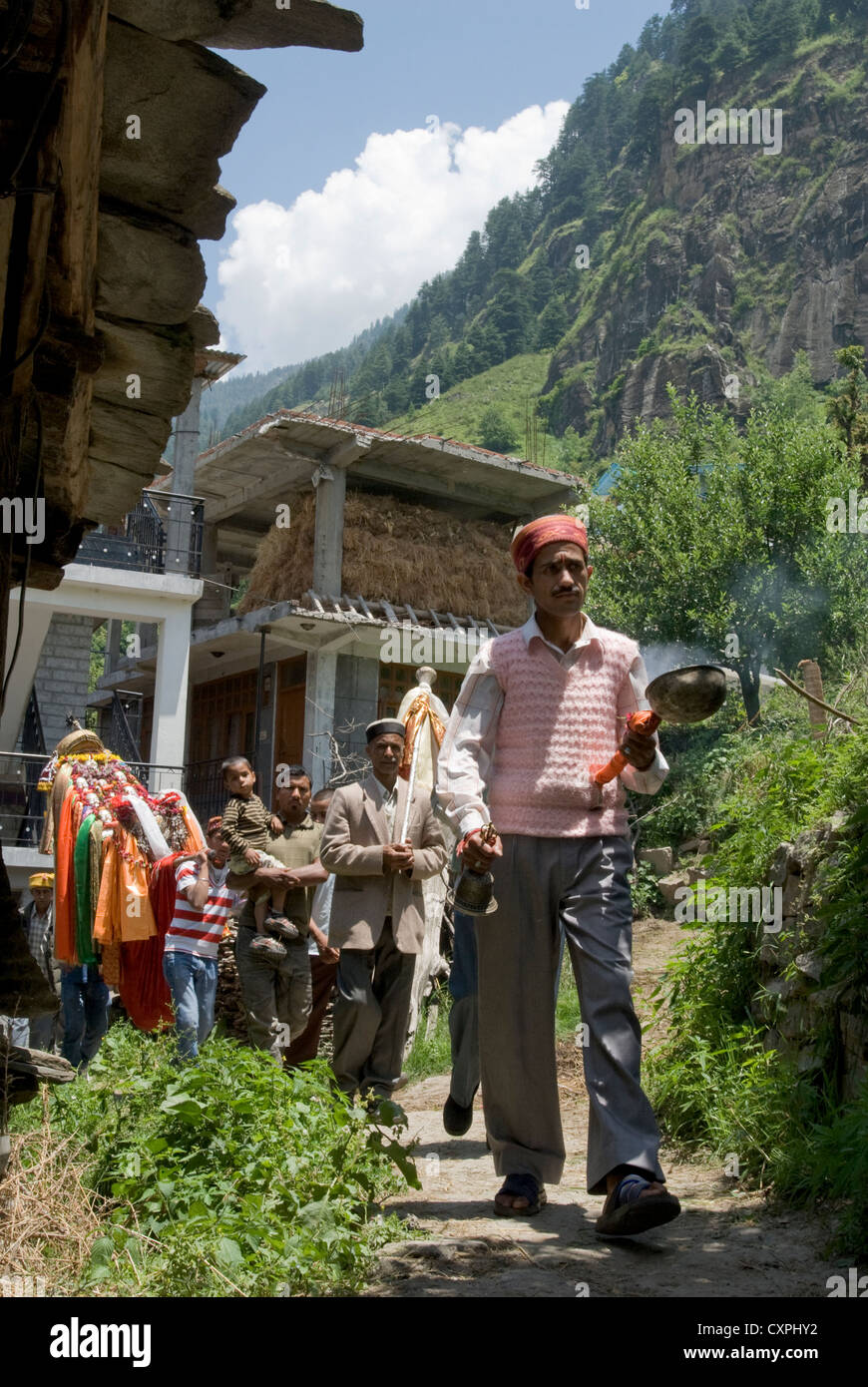A Hindu ritual procession makes its way through the village of Aleo ...