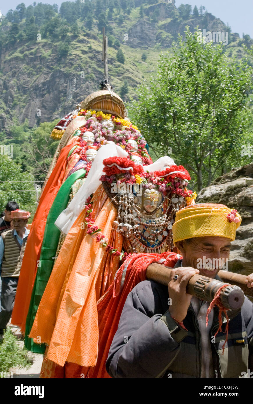 A Hindu ritual procession makes its way through the village of Aleo ...