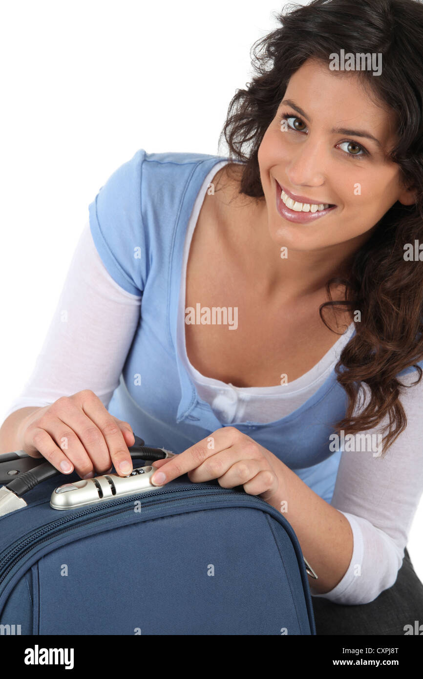 Woman packing her suitcase Stock Photo - Alamy