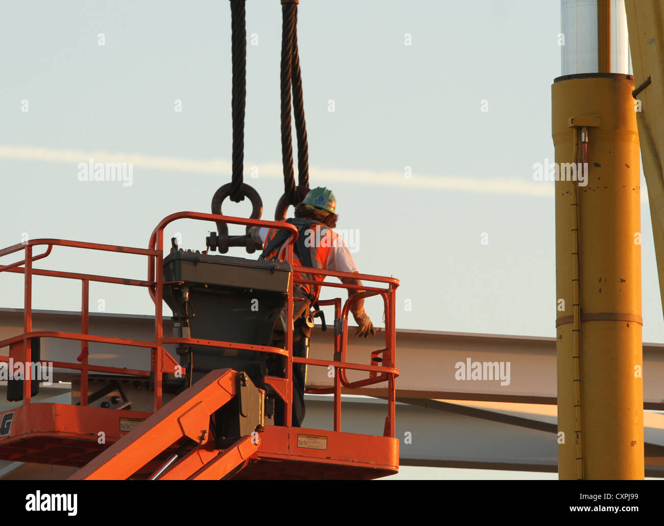 A construction worker oversees the installation of hooks for a 335,000 ...