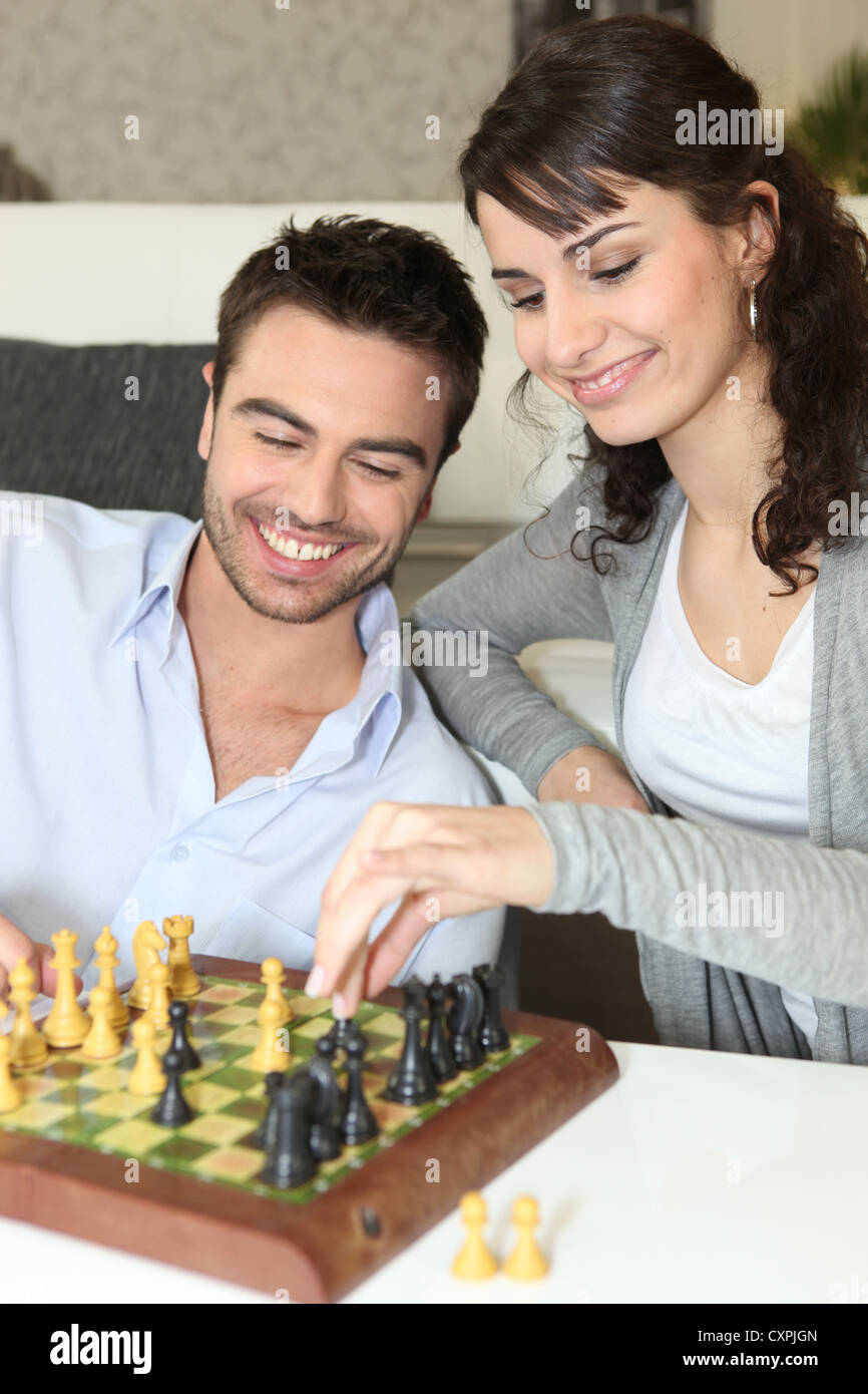 Couple playing chess Stock Photo - Alamy