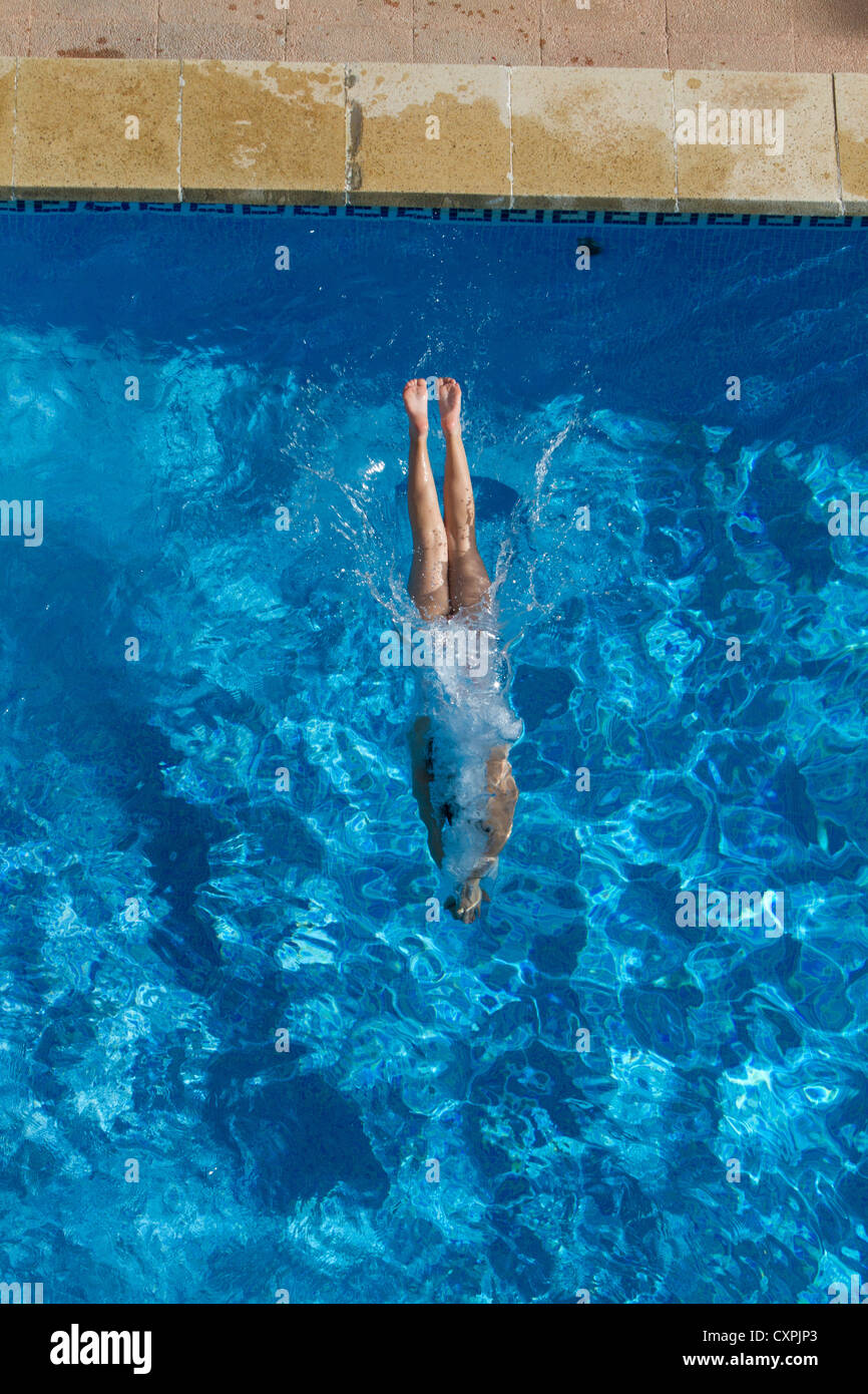 Girl diving in pool aerial Stock Photo - Alamy