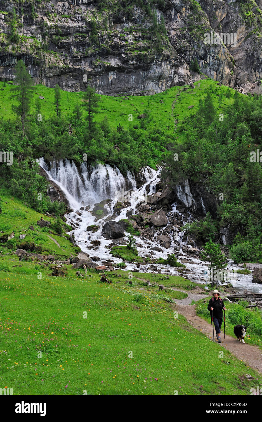 A woman hiker and her dog at the Sibenbrunnen falls, source of the ...