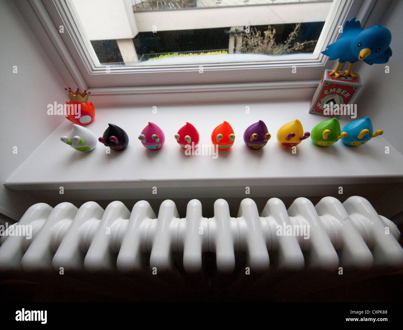 An arrangement of colorful figures upon the window ledge, in an office ...