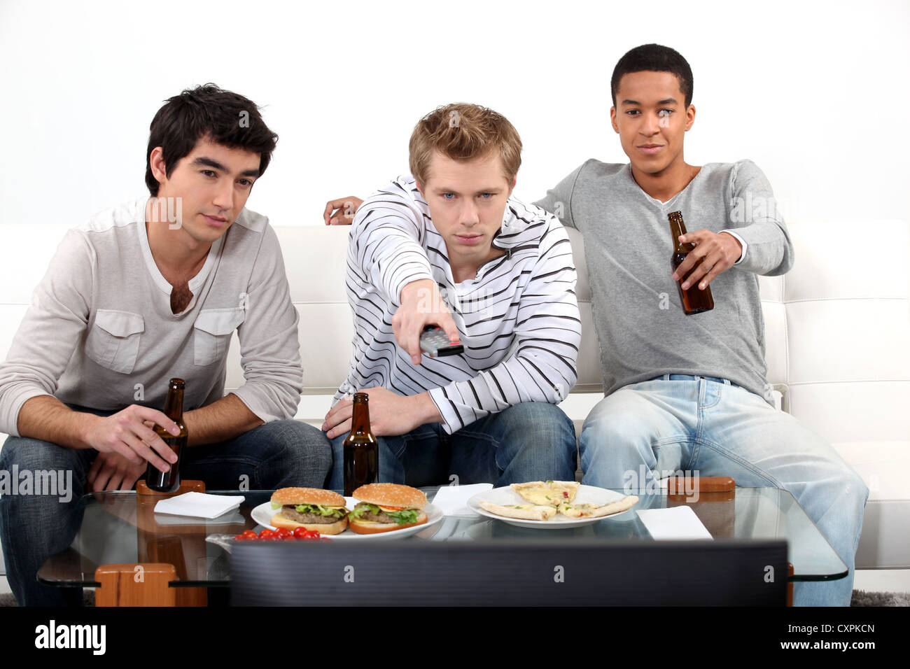 Young men watching a football game Stock Photo - Alamy