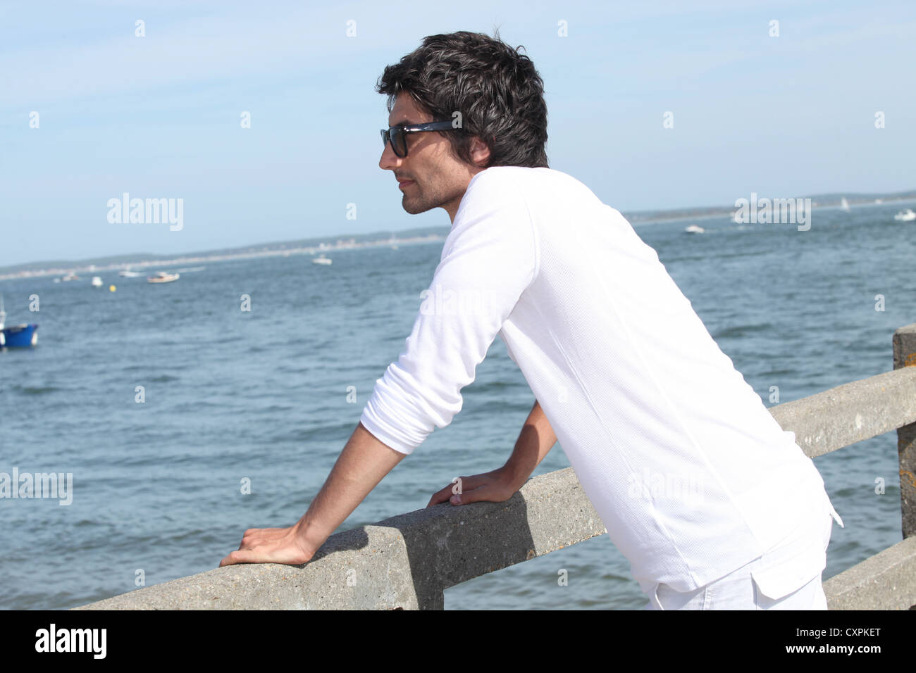Handsome man looking out to sea Stock Photo - Alamy