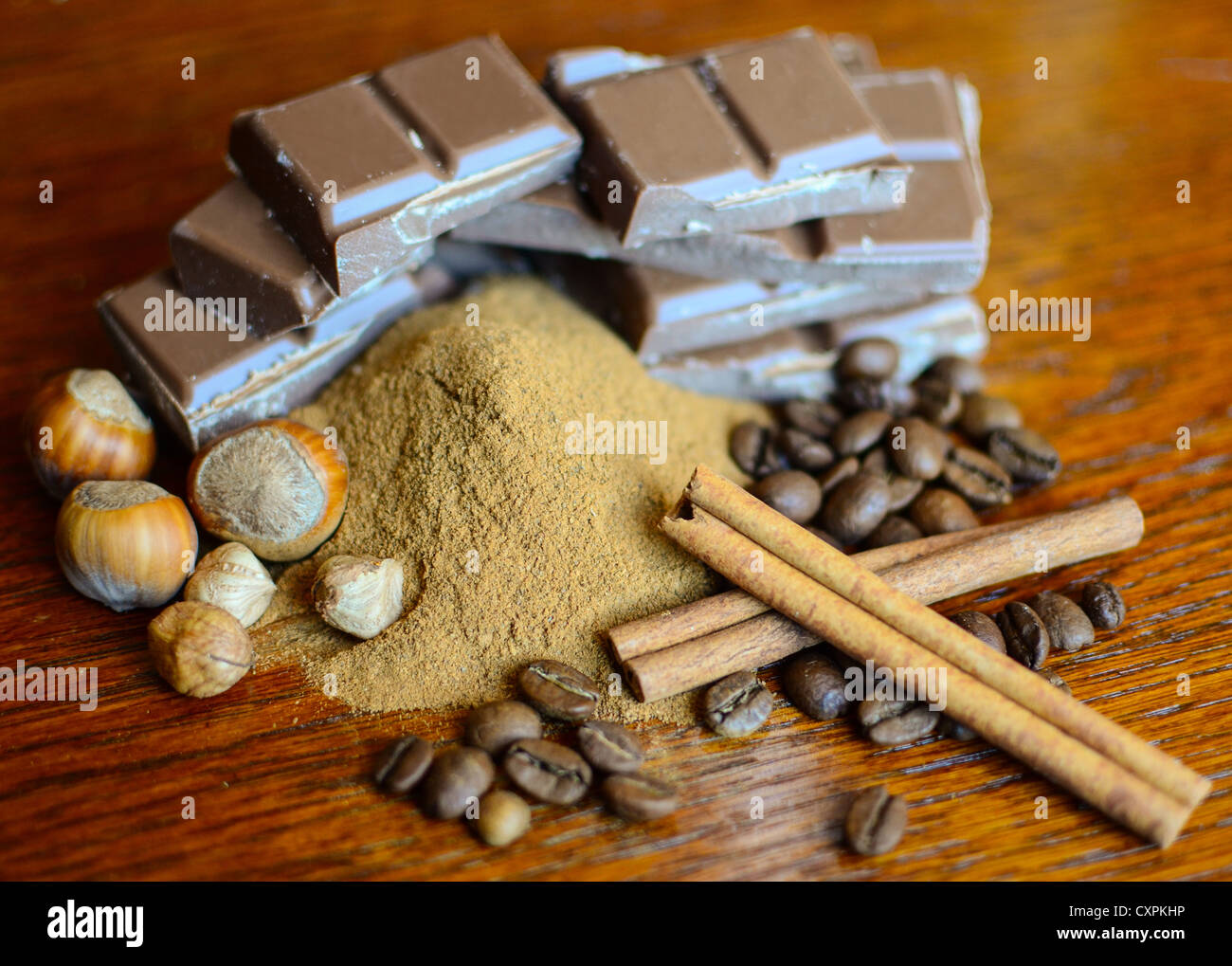 Chocolate background with hazelnuts and cocoa sticks Stock Photo - Alamy