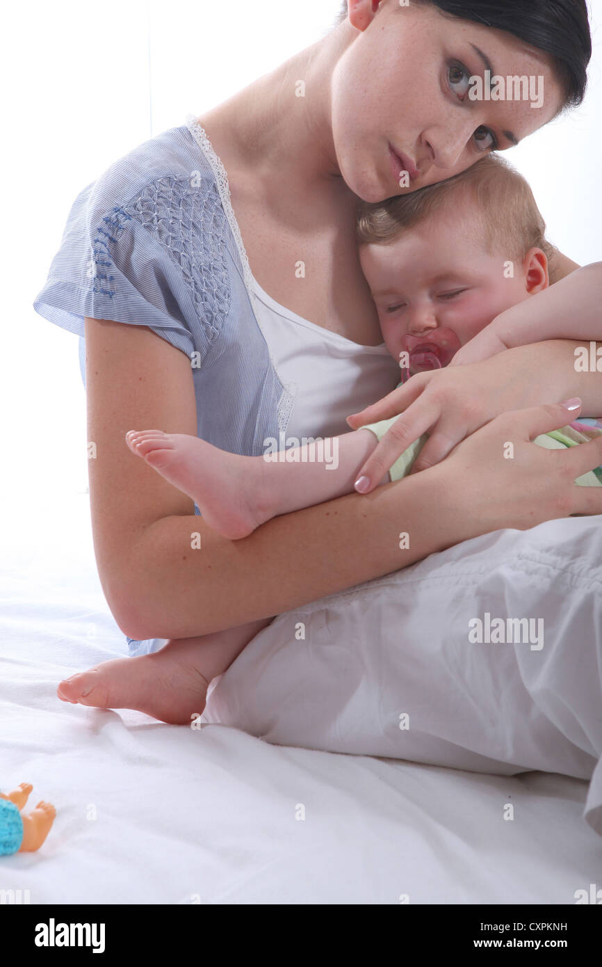 Mother rocking her baby Stock Photo - Alamy